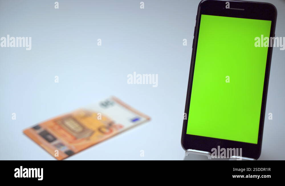 Modern smartphone with vertical green screen on foreground, and person ...