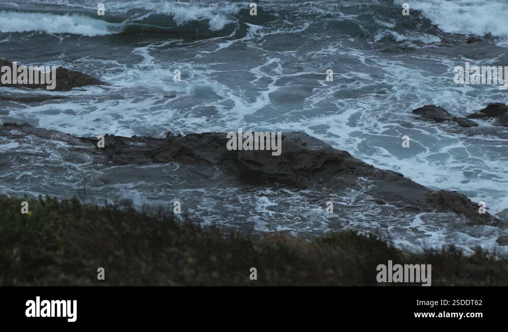 Waves crashing over rock at Cape Paterson Bay Beach, Overcast early ...