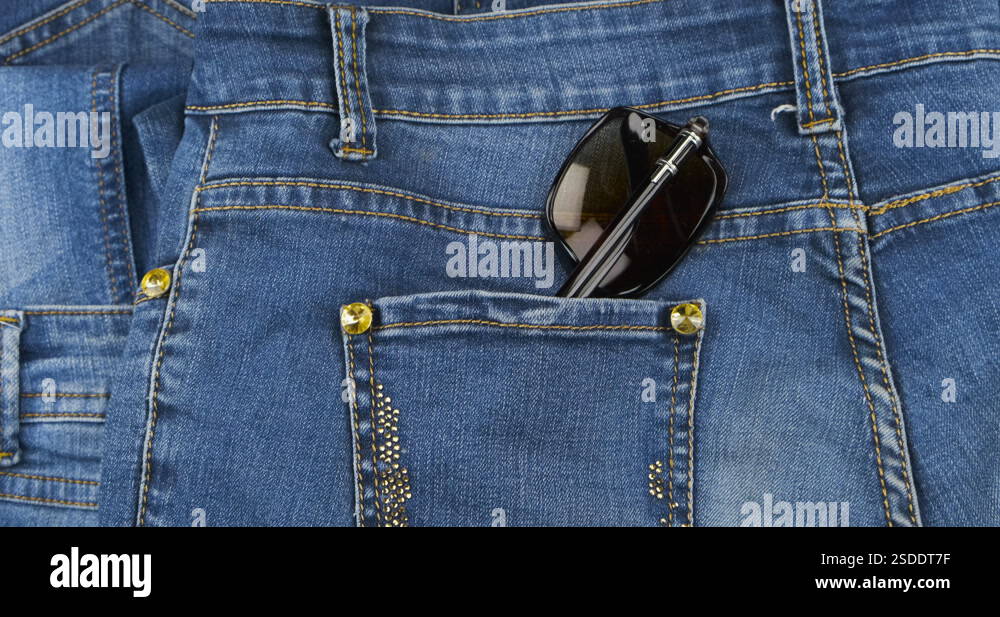 Sunglasses stick out of the back pocket of jeans. Fashion Stock Video ...