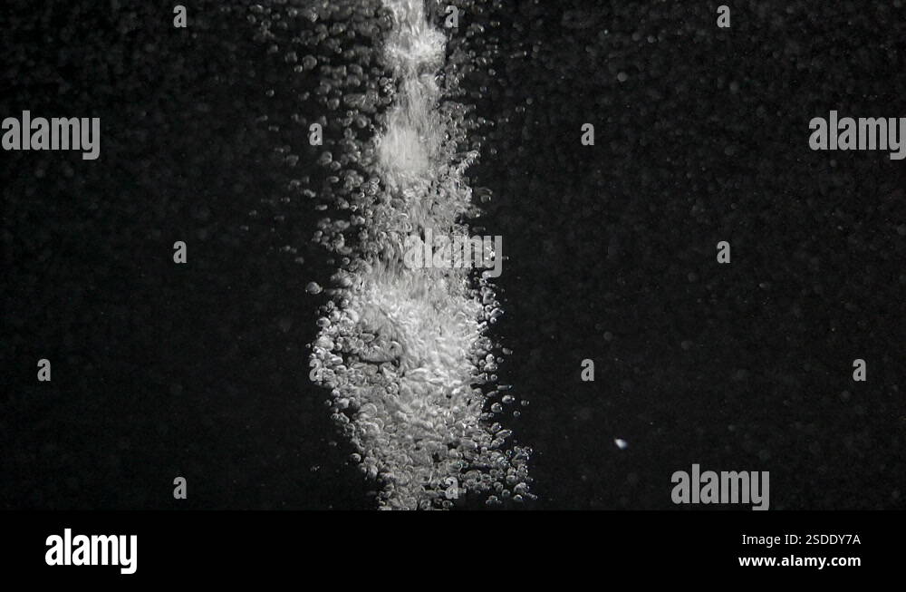 Bubbles blown down and rise back up slow motion black background Stock ...