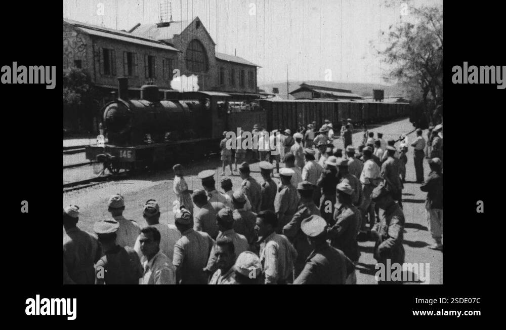 Men waiting for arriving train, women and children getting off ...