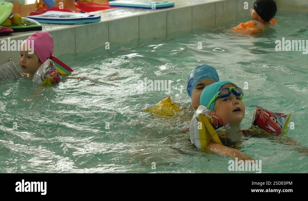 Kids learning to swim in swimming pool at kindergarten Stock Video ...