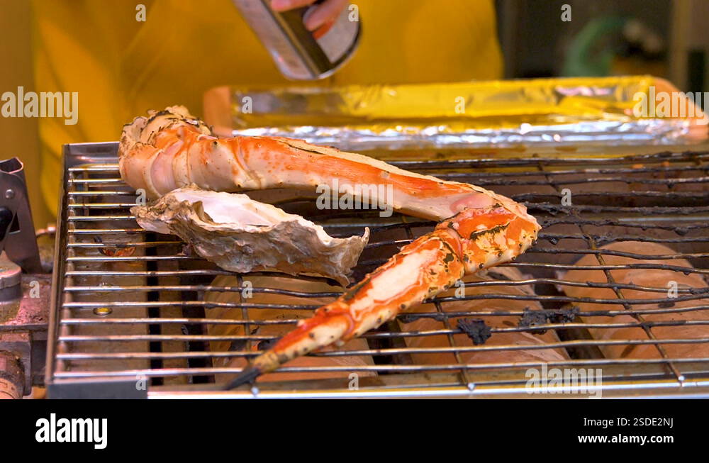 A huge crab feet on the grill pan in Tsukiji fish market in Tokyo Japan ...