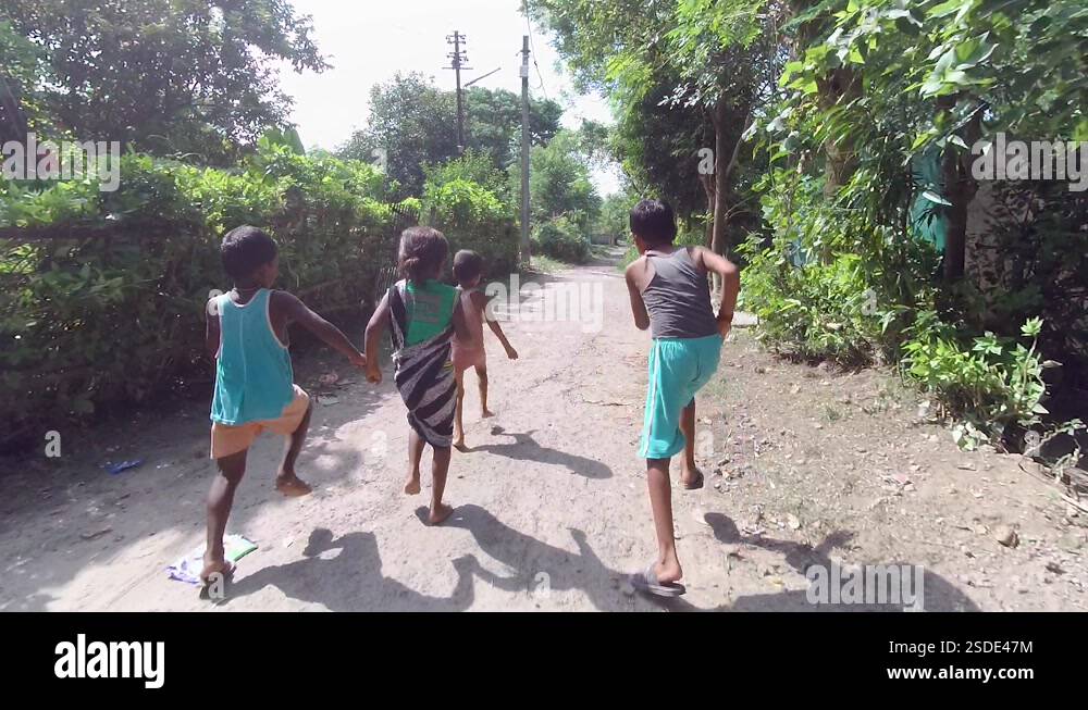 Little young poor kids running away from camera on street, happiness ...