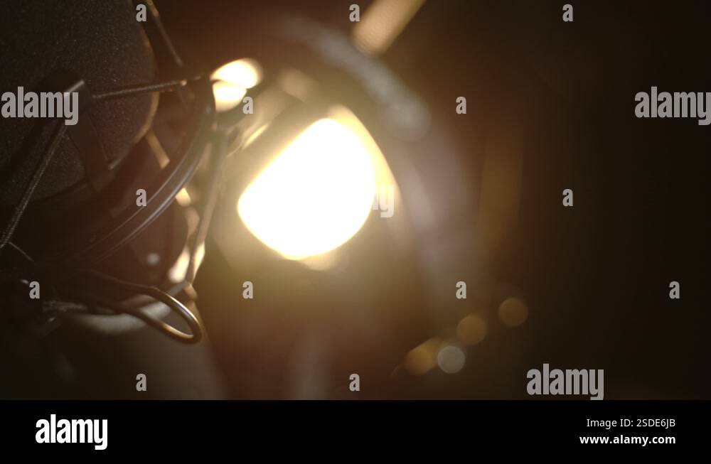 Slow pan of a podcast mic with backlighting for cinematic flare Stock Video Footage - Alamy