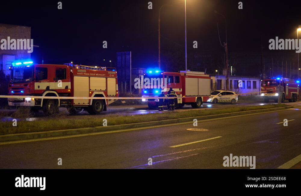 Police and firefighters with fire trucks and a police car on a scene in ...