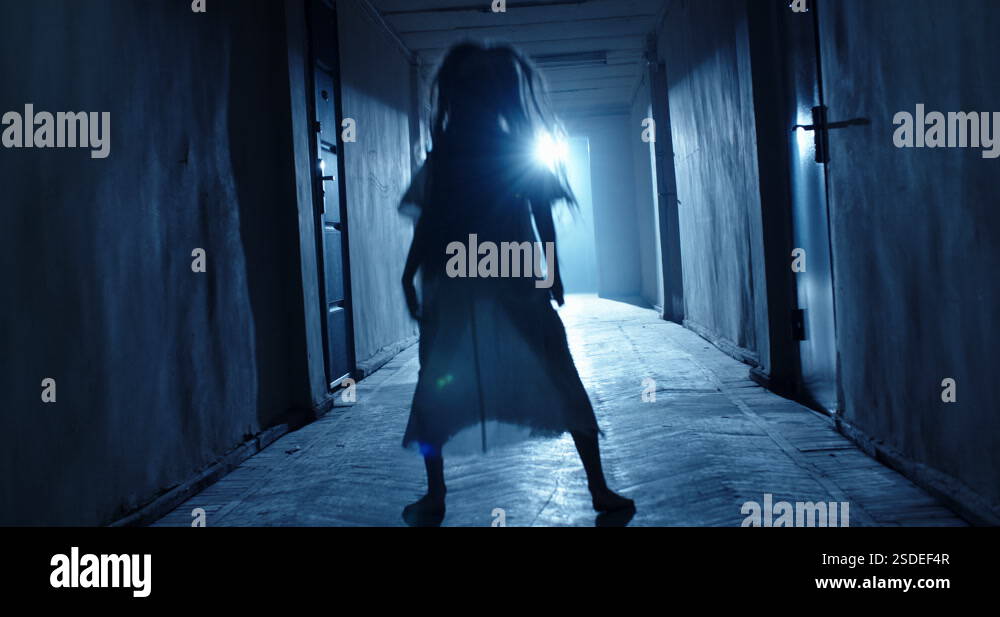 Little girl in white dress looking like a ghost carelessly running down ...