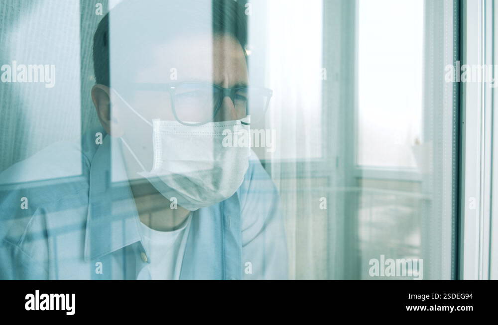 One man looks at window while staying home during quarantine Stock ...