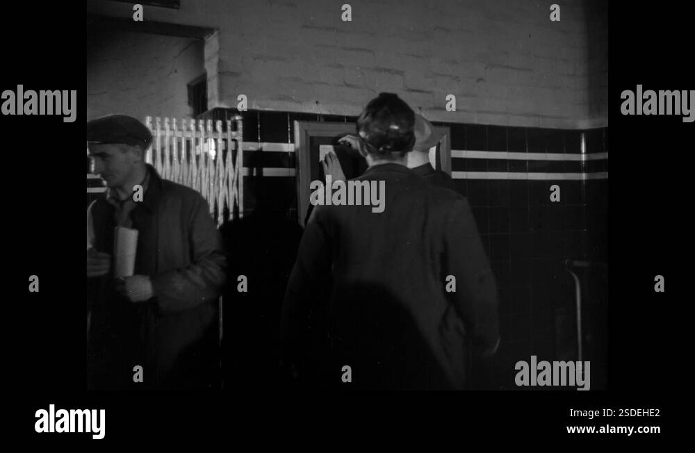 Factory workers walking in locker room and taking shower, South Wales ...