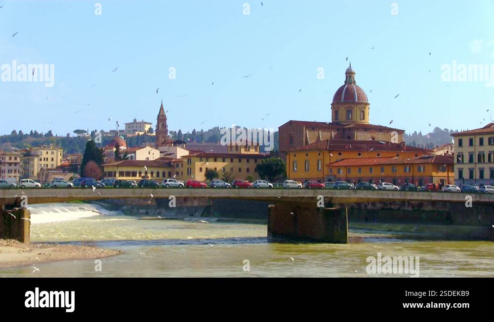 Parked cars on a bridge above the river in Florence Italy in the ...