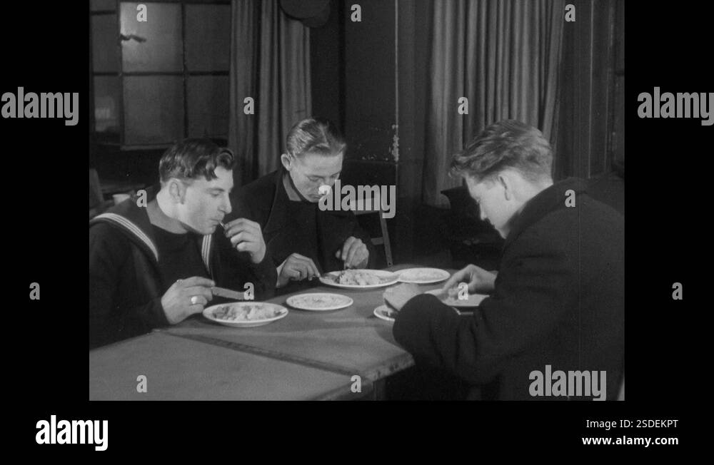 Soldiers and sailors eating their food at YMCA canteen, playing piano ...