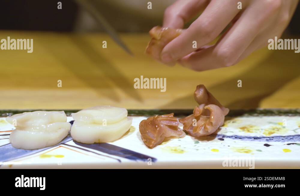 Male Chef Plating Fresh Meat For Sushi In A Chinese Restaurant In Stock ...