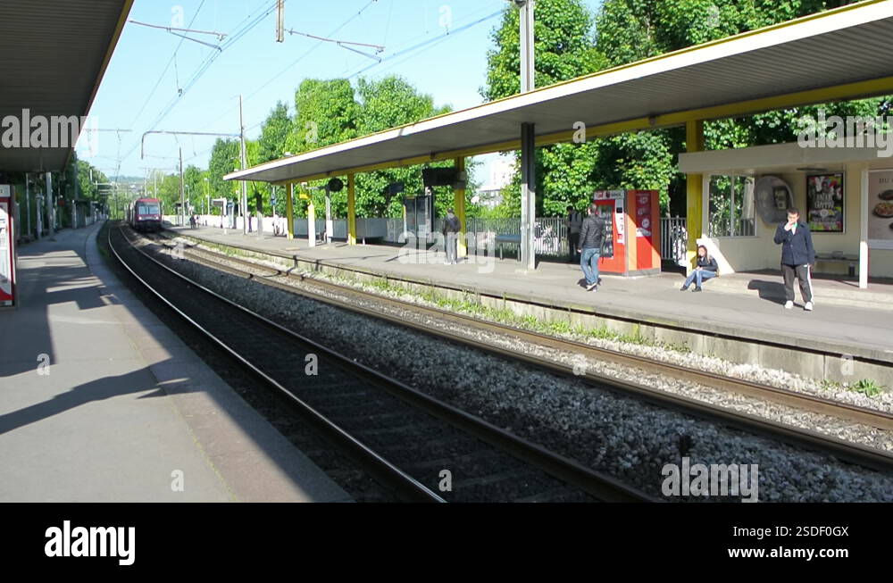 SNCF RER train arrival in the French station with people preparing to ...