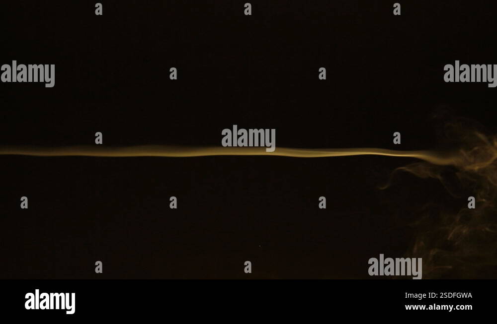 Beautiful gas movement on a black background. Twists of yellow smoke on ...