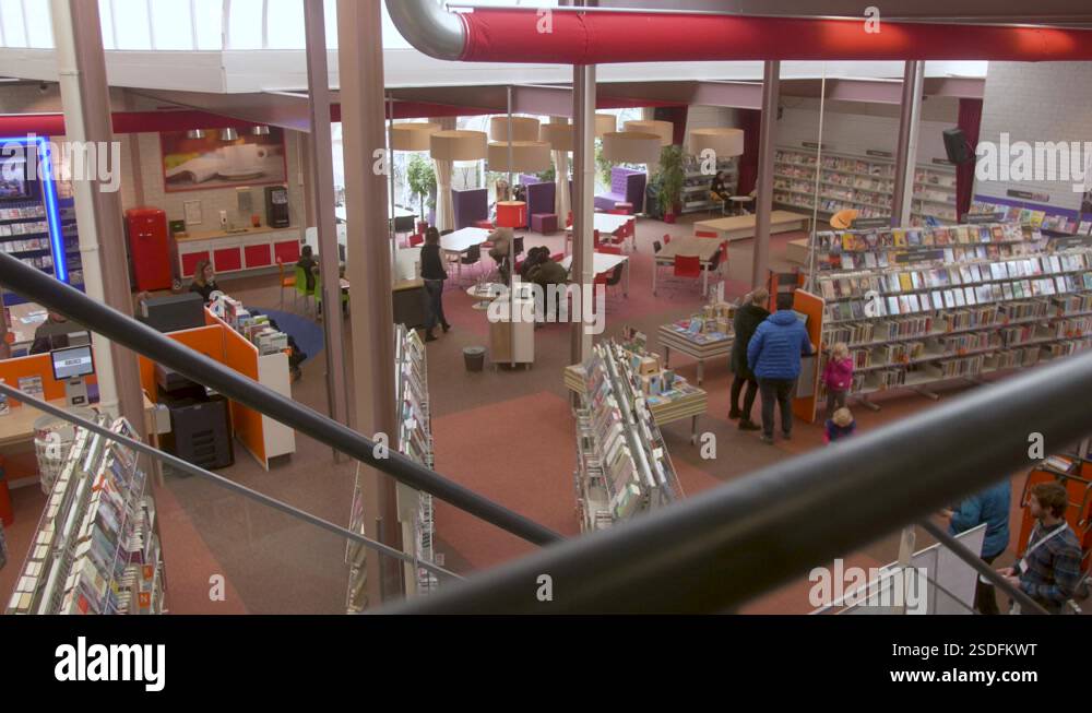 People walking and reading in a library Stock Video Footage - Alamy