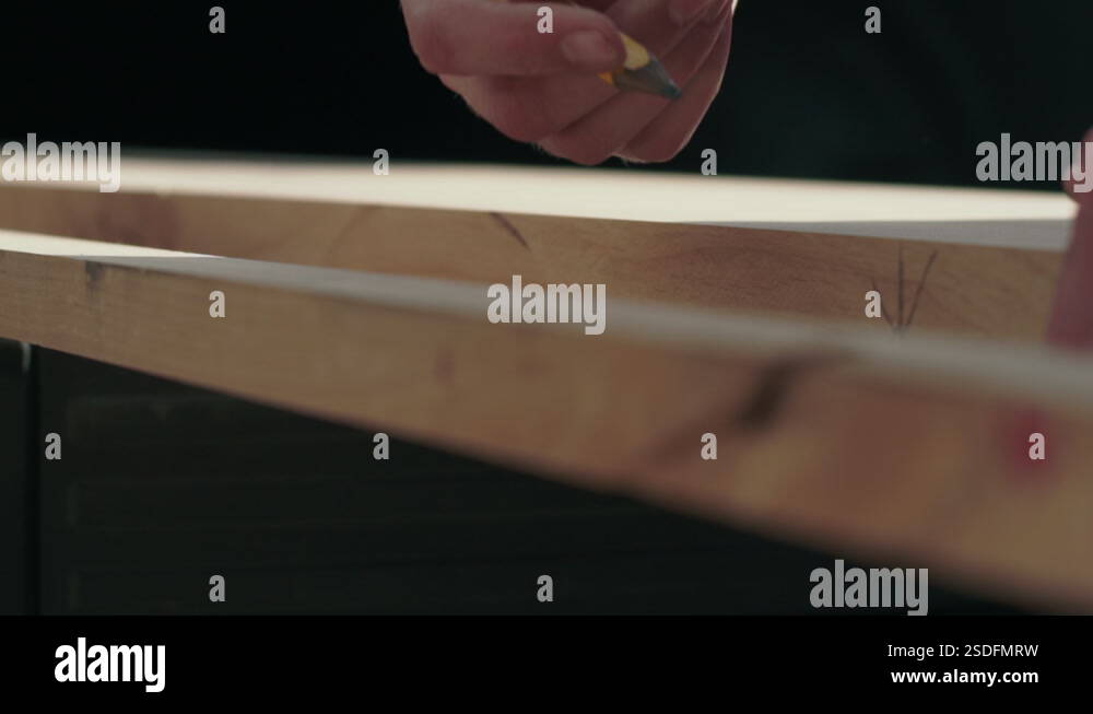 Carpenters hands measure and mark wood plank with pencil. HD slow ...