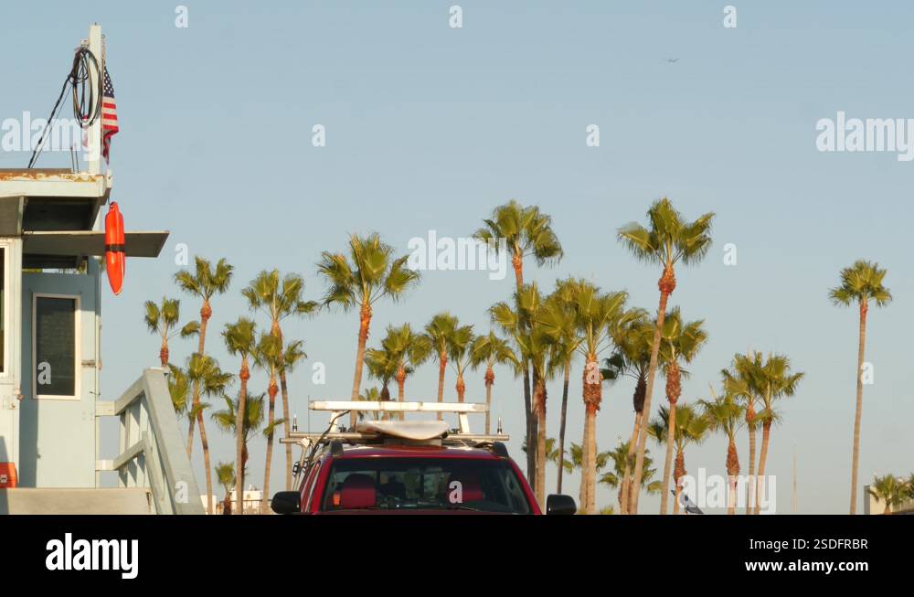 Iconic retro wooden lifeguard watch tower and baywatch red car. Life ...