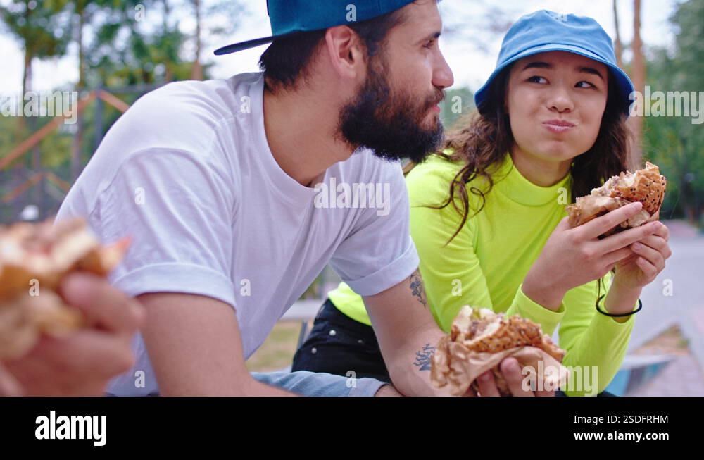 Break time for a group of hungry young people multiethnic they enjoy ...