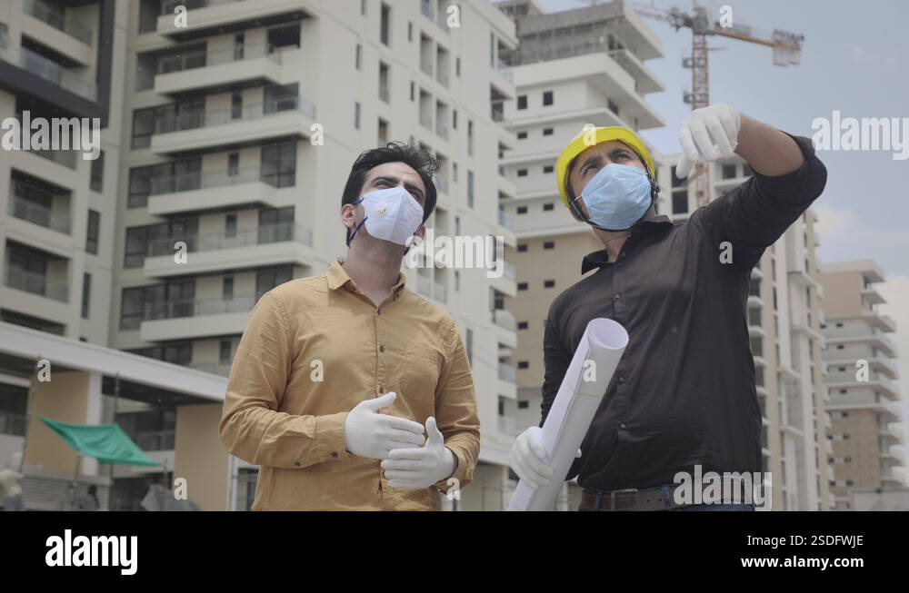 Two men engineers wearing face masks and hand gloves Stock Video Footage - Alamy
