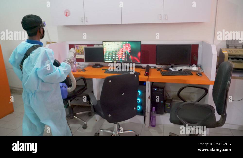 Sanitation worker sanitizing workplace with Ultra Low Volume fogging ...