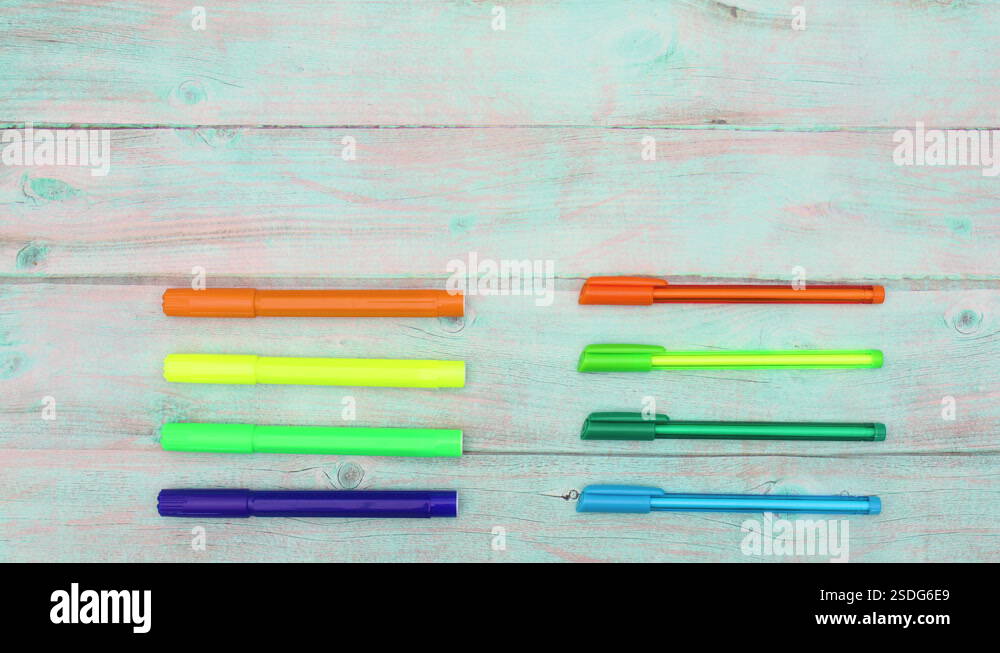Pencils and felt pens in different colors appear and disappear. Stop ...