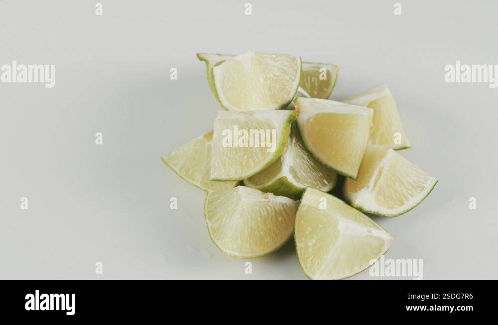 Close up, pieces of lime on white rotating table, concept of citrus ...