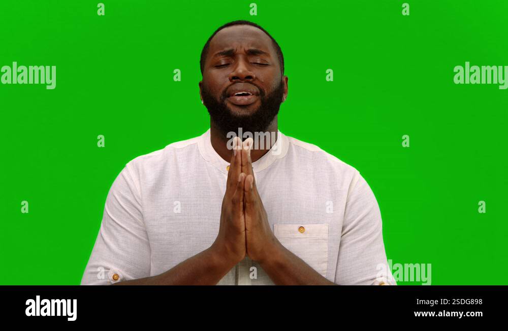 Hopeful man keeps palms in pray, asks for help, wants wishes come true ...