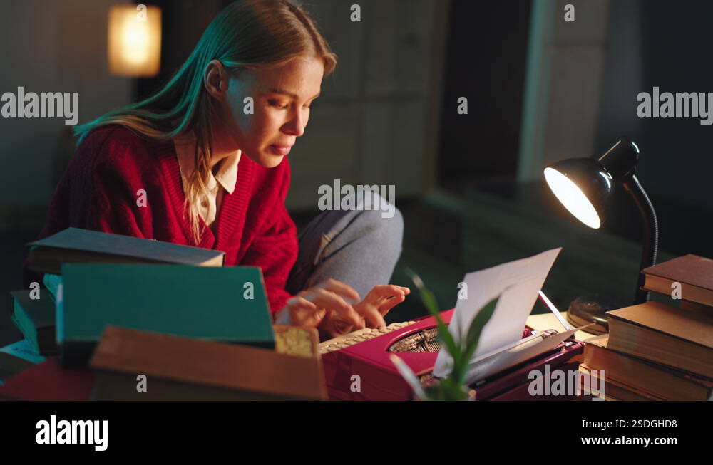 Attractive young woman very concentrated typing some college project on ...
