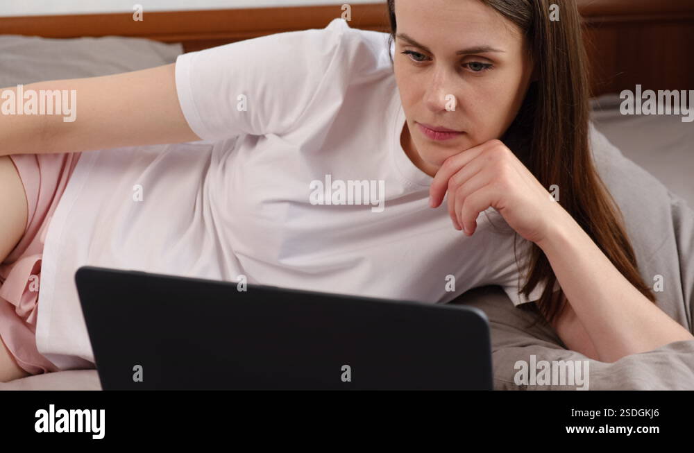 Pregnant woman lying in bed at home making distance video call online chat Stock Video Footage ...