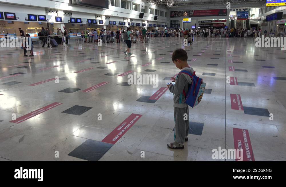 People queues for flight registration and a boy with gadget alone Stock ...