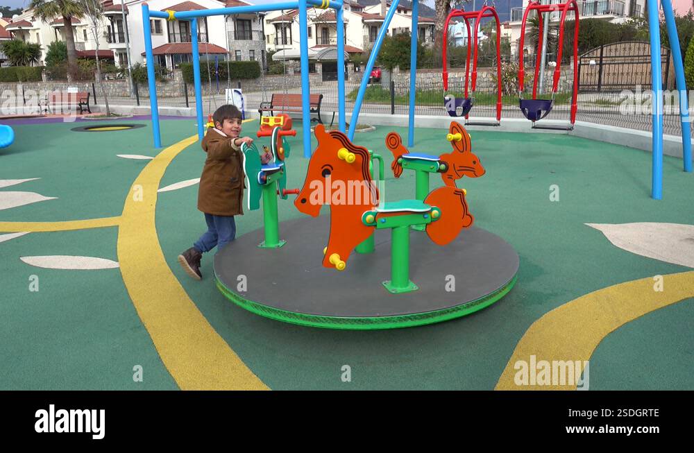 Child childhood children play playground playing roundabout Stock ...