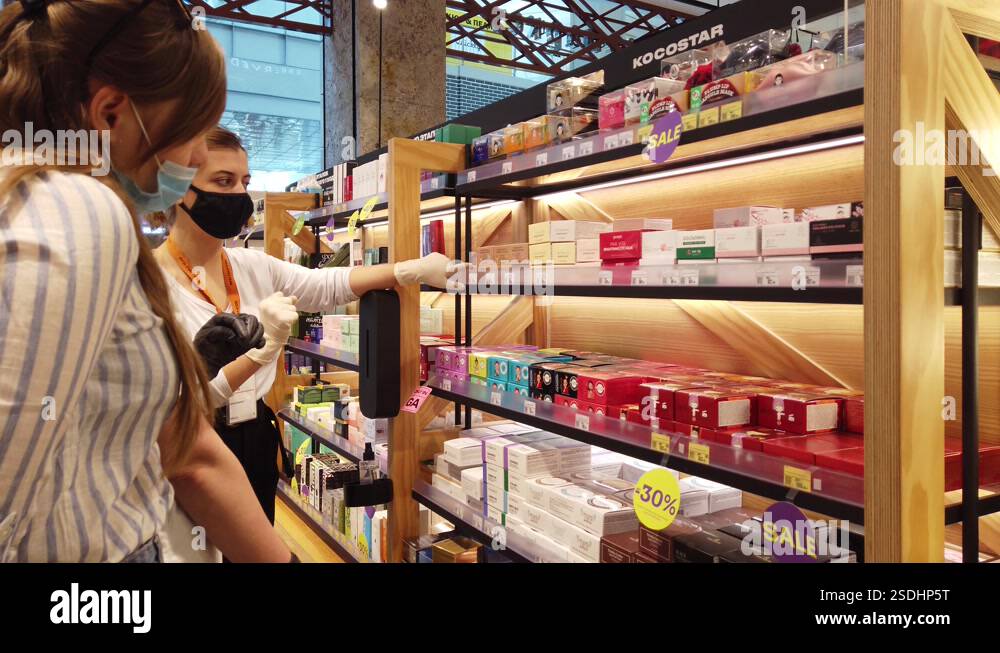 Girl in the store of cosmetics and perfume chooses purchases for her ...