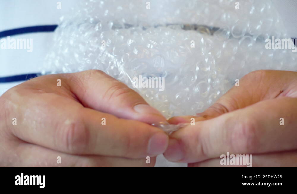 emotional and physical stress relief.man hands tearing the packaging ...