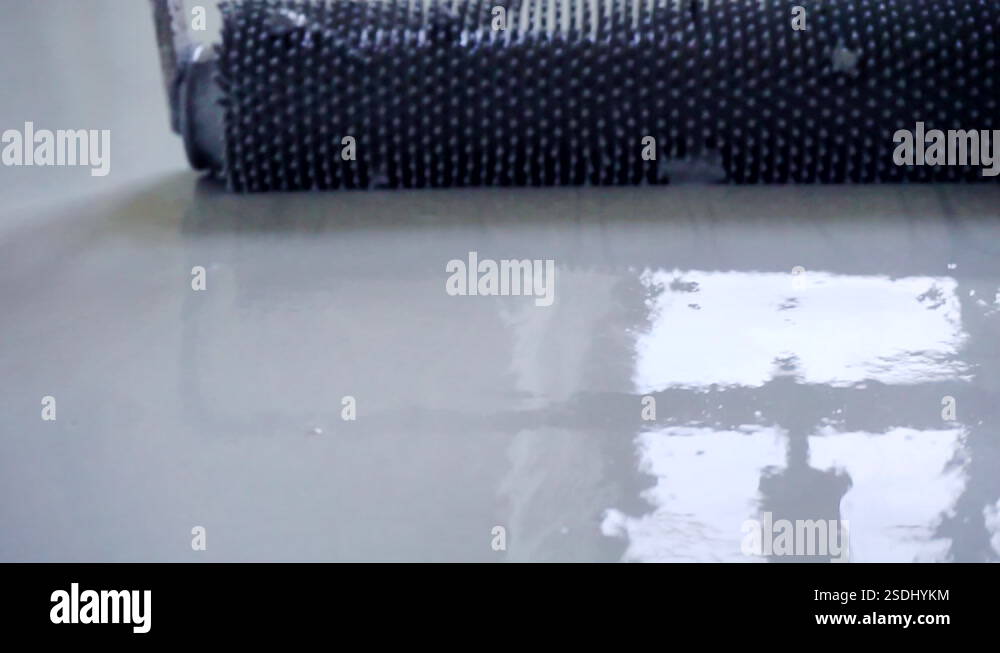 leveling the surface of the mortar with a special roller for leveling ...