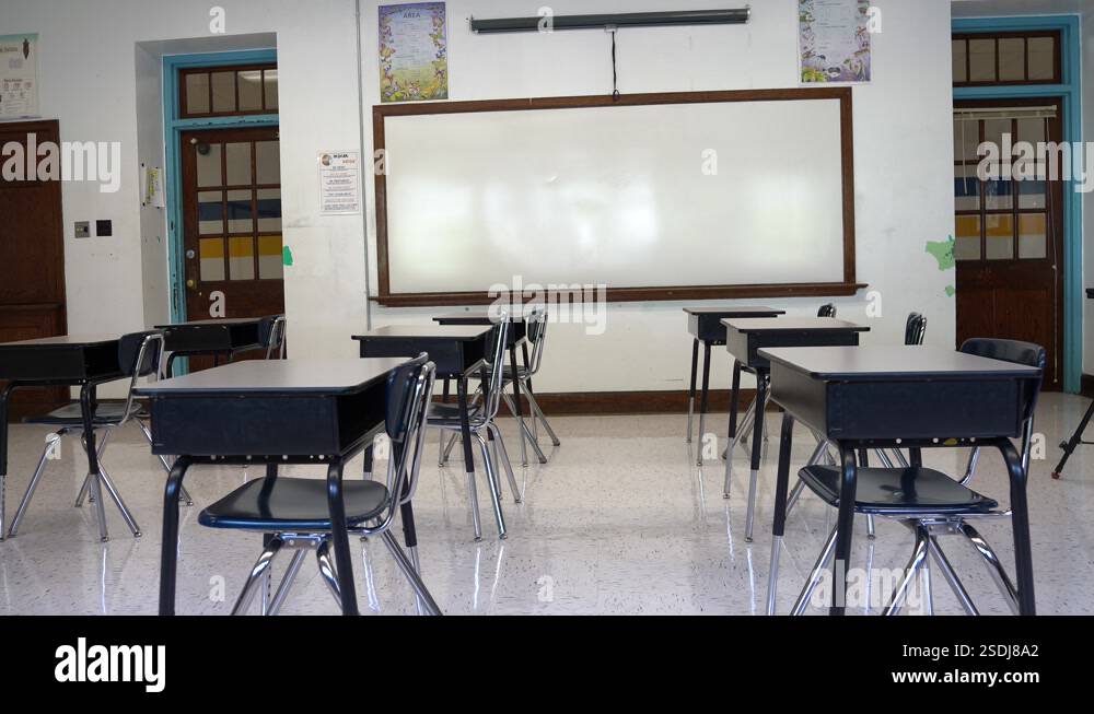 Motion to the left showing empty school classroom side view with chairs ...