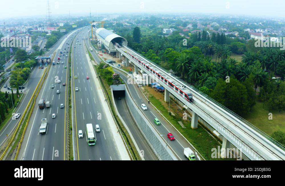 New LRT station with traffic on toll road Stock Video Footage - Alamy