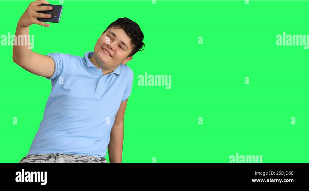 Teenage boy taking selfie at green screen background Stock Video ...