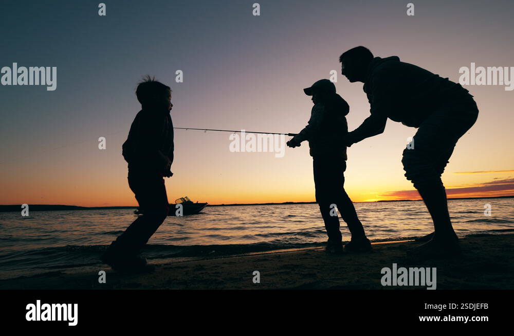 Father is helping his happy kids to fish in a lake Stock Video Footage ...