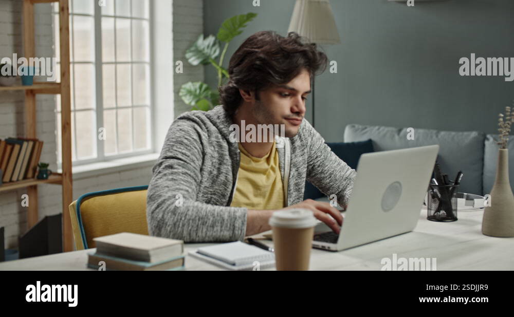 Remote employee working at home, completing his task. Young caucasian ...