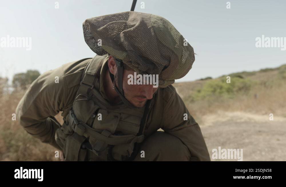 Army infantry soldier carrying his wounded fellow warrior, while ...
