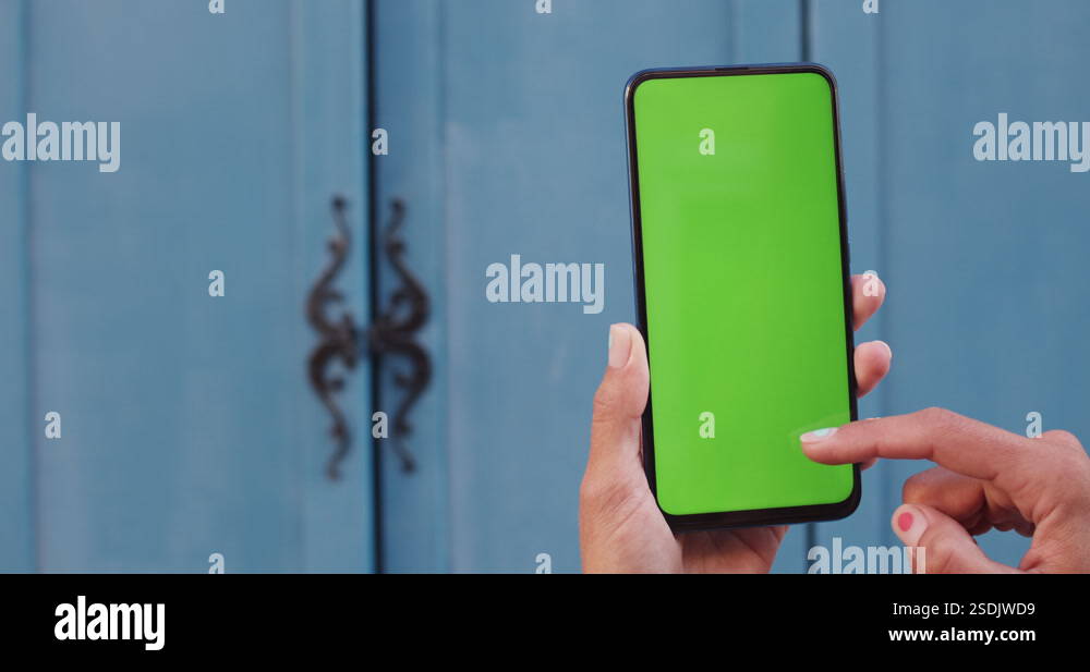 Close up view of female hand holding mobilephone and scrolling blank ...