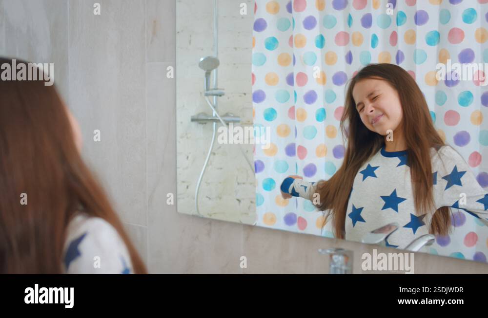 Pretty little girl in pajama yawning and stretching looking in mirror at Stock Video Footage - Alamy