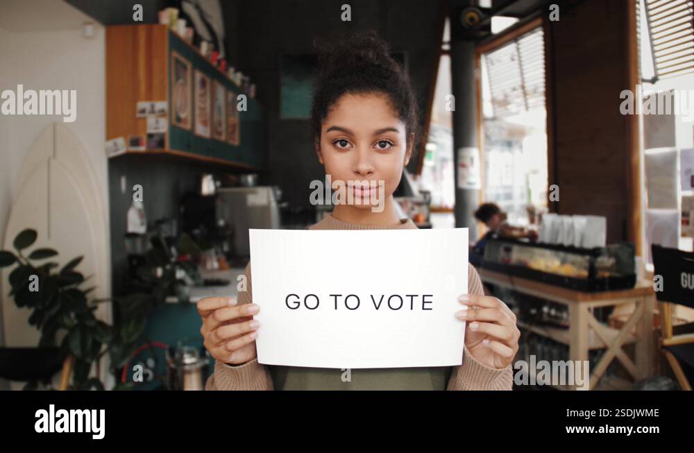 Black african american Woman shows cardboard with Go Vote sign near ...