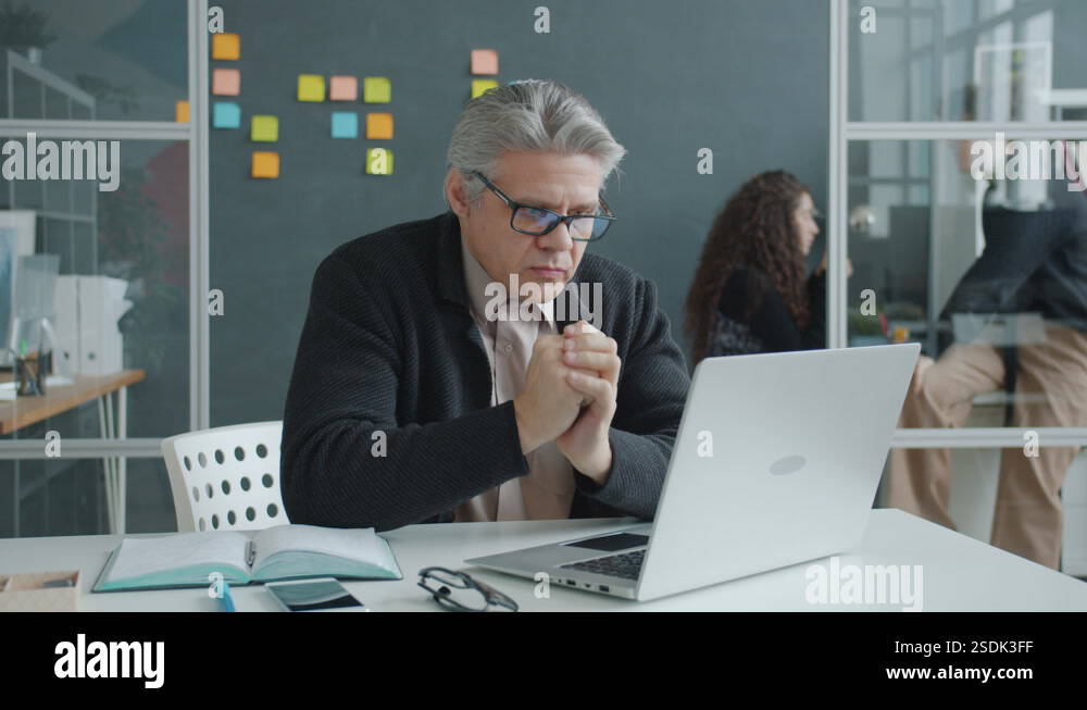 Unhappy mature man office worker using laptop and feeling failure in ...