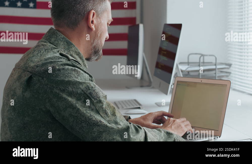 Army Officer Working Looking at Document and Typing on Laptop Stock ...