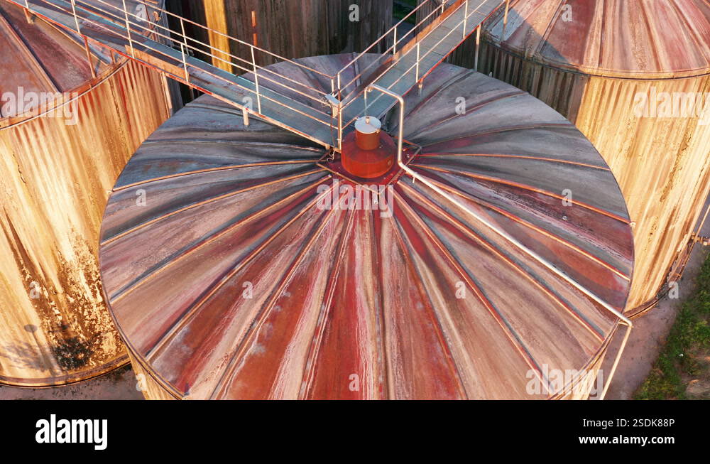 Tower silos in an industrial plant - rusty and stained. Aerial view ...