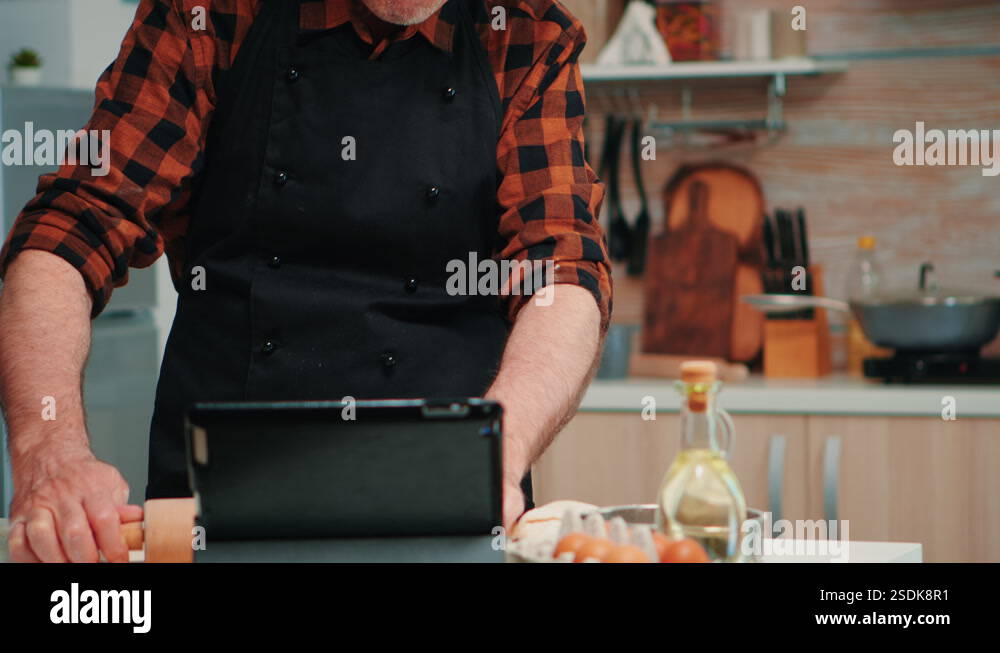 Baker using tablet cooking home cakes Stock Video Footage - Alamy