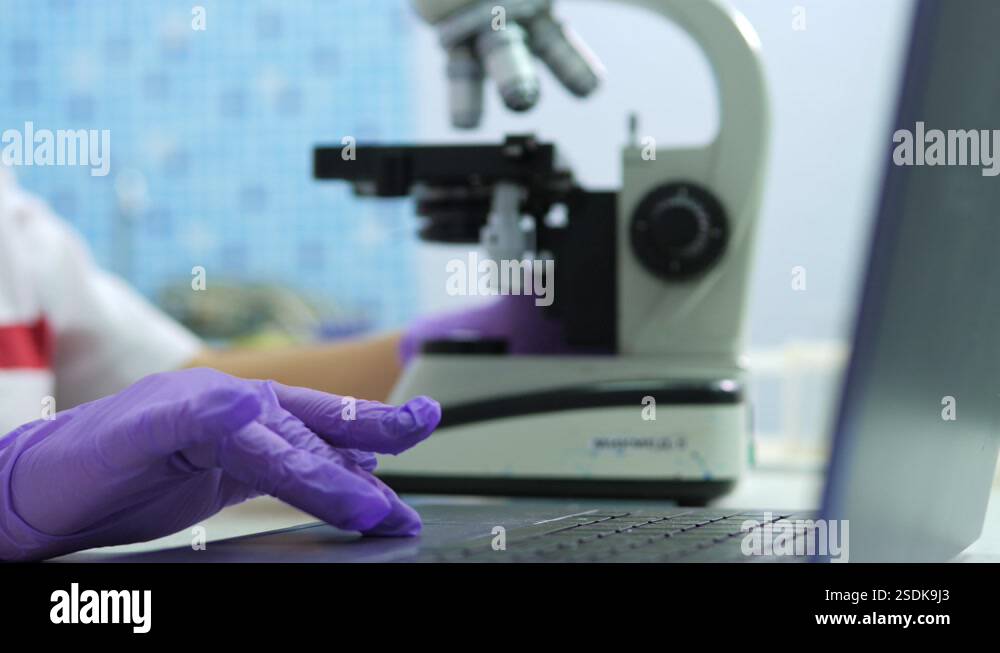 Microbiologist is testing a sample of blood contaminated by Coronavirus ...