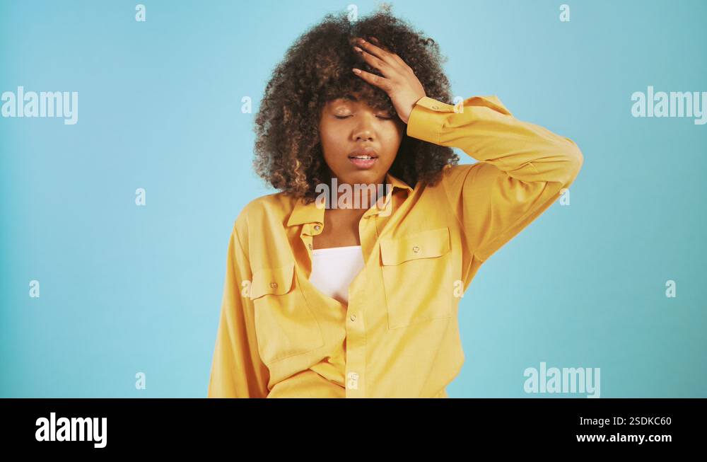 Dark-skinned female making facepalm hand gesture, rolling her eyes and ...