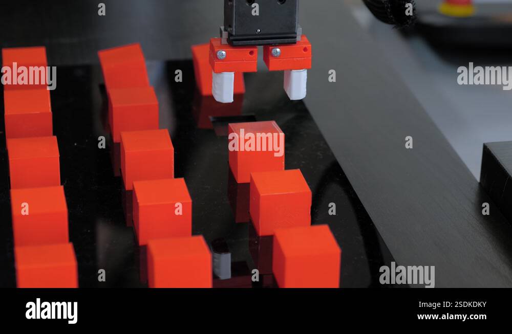 Pick and place robotic arm manipulator moving red toy blocks at robot exhibition Stock Video ...